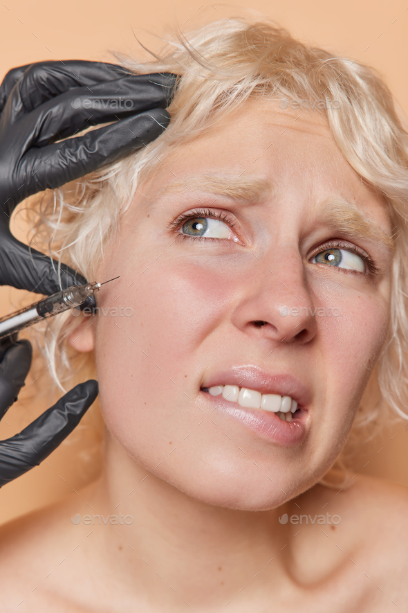 Worried European woman has beauty injections session afraids of painful ...