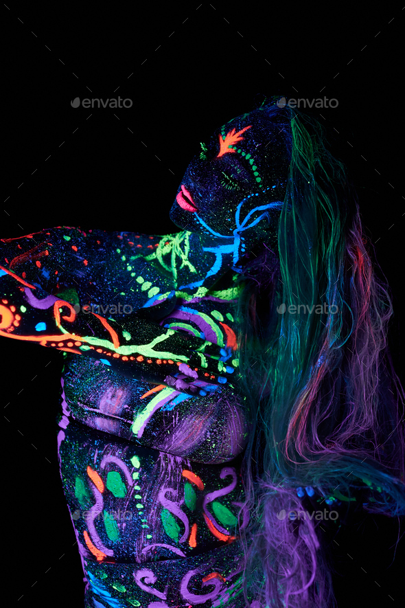 woman body art body dancing in ultraviolet light. Bright abstract ...