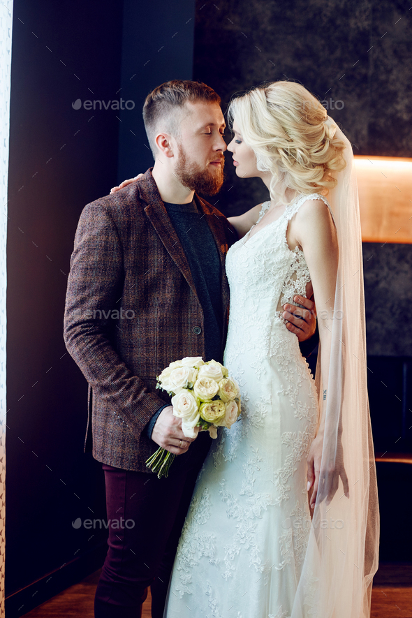 Couple hugged and kissed after the marriage. The bride and groom hug ...