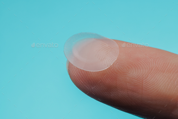 Girl with acne stick round acne patch on her cheek. Facial rejuvenation ...