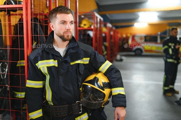 A firefighter puts on a fire uniform at the fire department Stock Photo ...
