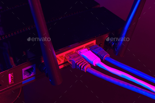 Cables plugged in a Wi-Fi router on dark background Stock Photo by ...