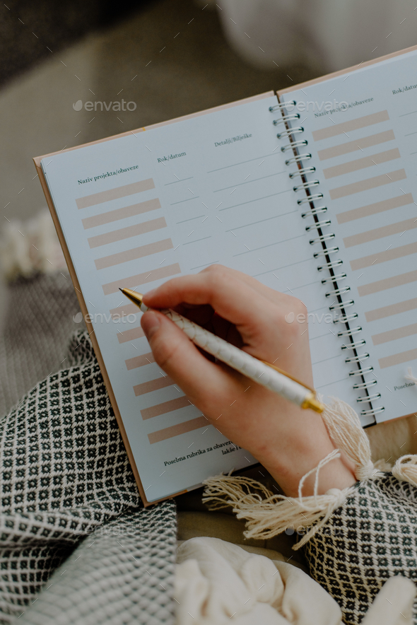 Top view of a female hand with pen writing notes in a journal Stock ...