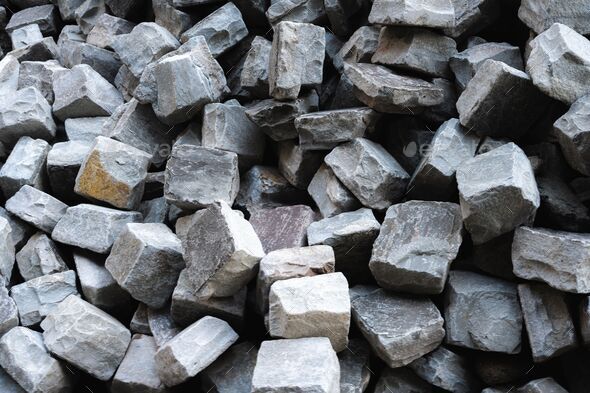 Pile of bricks in various shapes and sizes, stacked haphazardly on top ...