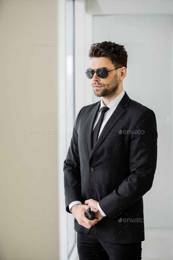 surveillance, bodyguard standing with walkie talkie, man in sunglasses ...