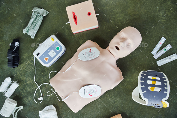 top view of CPR manikin, automated external defibrillator, wound care ...