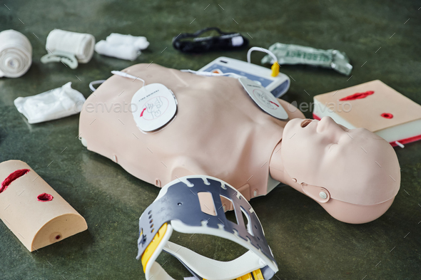 CPR training manikin near automated external defibrillator, wound care simulators, neck brace ...