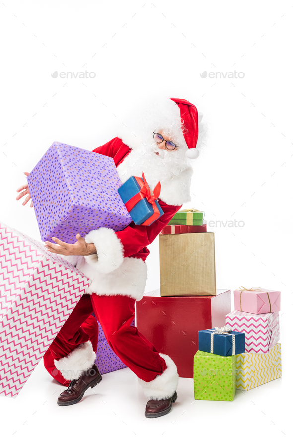 santa claus in eyeglasses dropping pile of gift boxes isolated on white ...