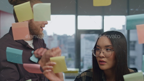 Angry man tearing sticker at office closeup. Team arguing at strategy ...