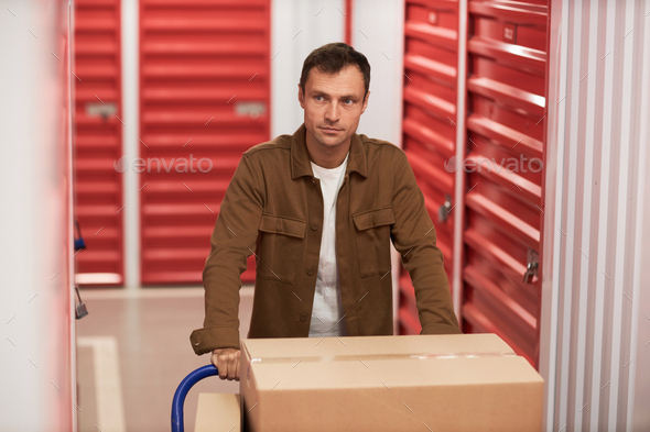 Man Pushing Cart with Cardboard Boxes Stock Photo by AnnaStills | PhotoDune