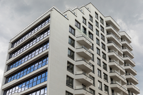 Exterior view of contemporary tall apartment building premises with ...