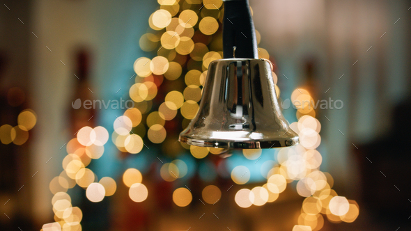 Shaking and ringing bell with blurred Christmas background Stock Photo ...