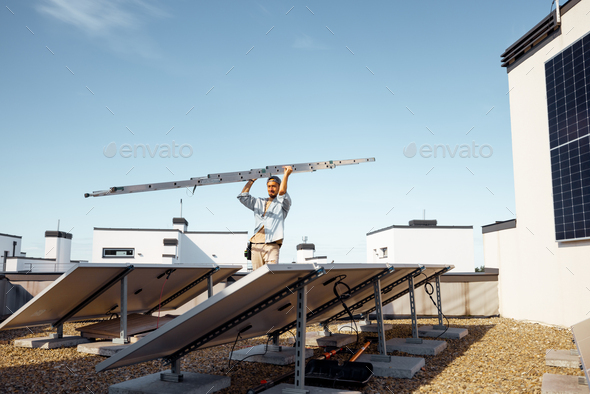 Man carries ladder during solar panels installation Stock Photo by ...