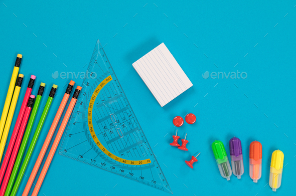 Colored crayons, transparent triangular ruler, pile of white scratch ...