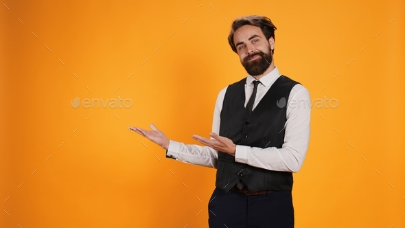 Skilled classy butler pointing aside Stock Photo by DC_Studio | PhotoDune