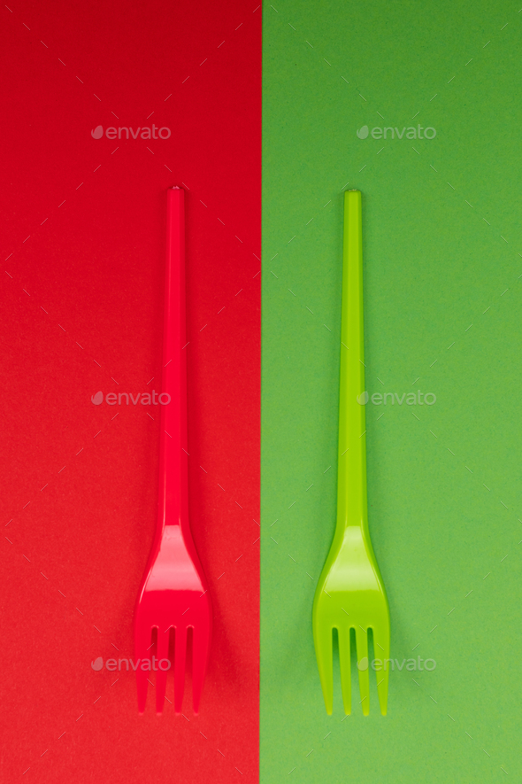 Pair of plastic forks in red and green atop of background Stock Photo ...
