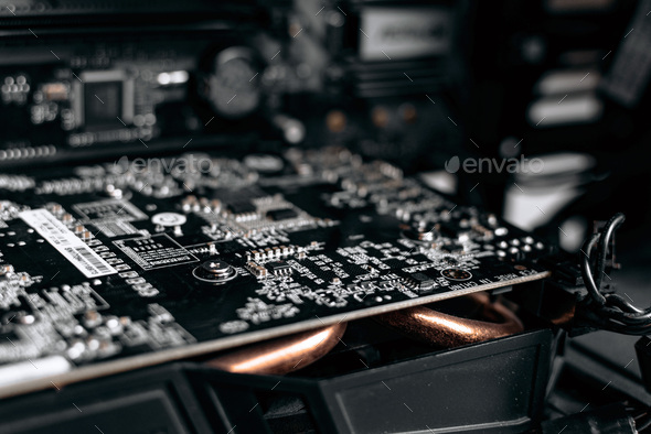Close-up photo of dark circuit board of graphics card in desktop ...