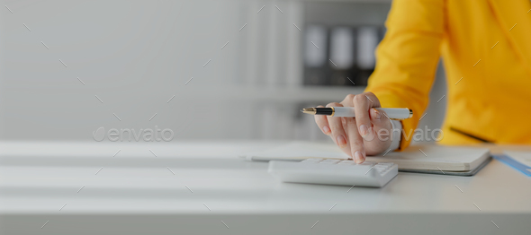 Accountant calculating numbers on calculator, Auditor is working on ...