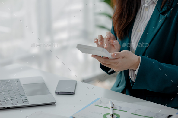 Accountant calculating numbers on calculator, Auditor is working on ...
