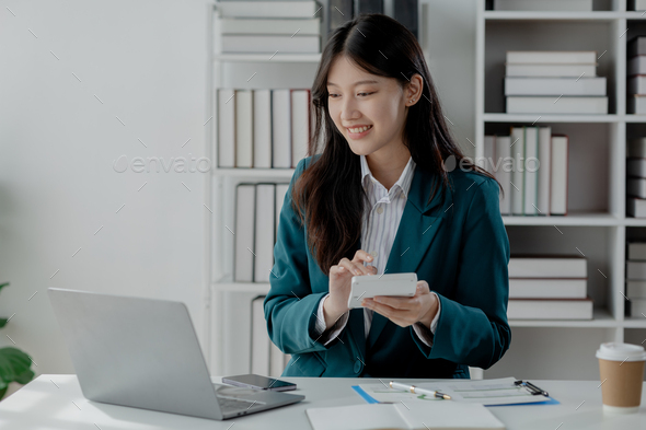 Accountant calculating numbers on calculator, Auditor is working on ...
