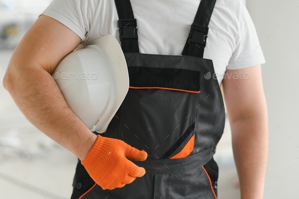 Close up of a construction worker's hand holding project documents and ...