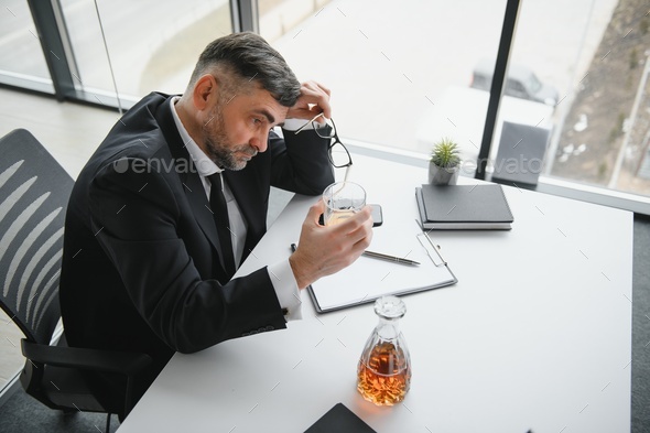 Alcoholism at work. Tired employee drinking alcohol at workplace, can ...