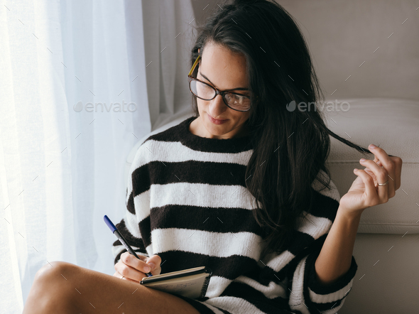 Charming woman writing in notepad Stock Photo by ADDICTIVE_STOCK ...