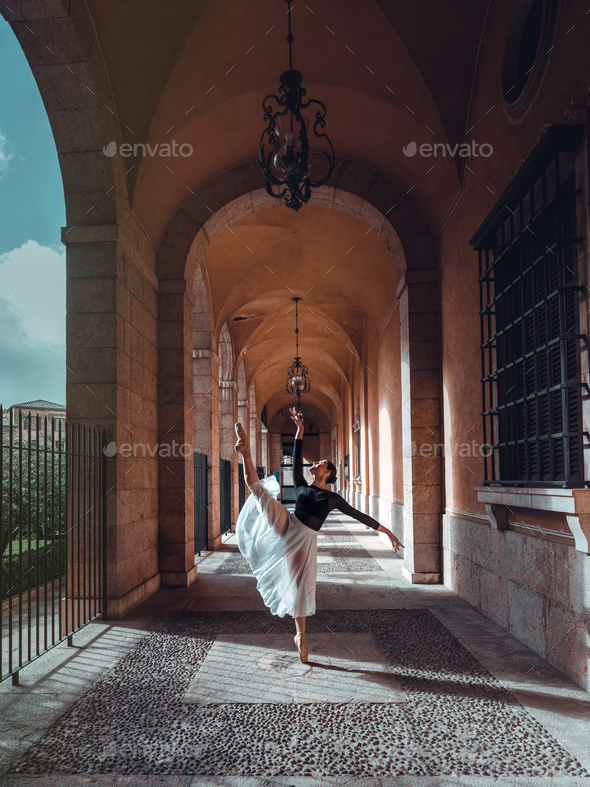 Gracious female ballet dancer raising leg in arched passage Stock Photo ...