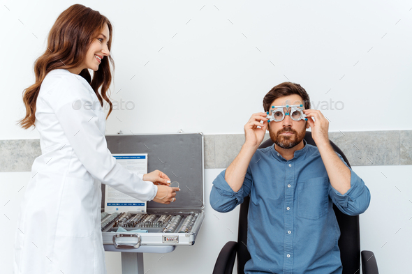 Ophthalmologist checking diagnose eyesight myopia, hyperopia young man ...