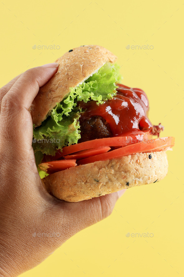 Female Hand Hold Mini Burger Stock Photo by ikadapurhangus | PhotoDune