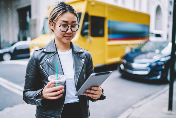 Japanese female blogger in leather jacket browsing media content on ...