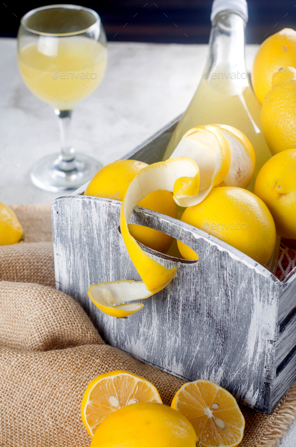 Traditional Italian liqueur Limoncello liqueur and fresh citrus fruits ...