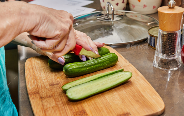 Chef prepares the cucumbers for stuffing and baking Stock Photo by ...