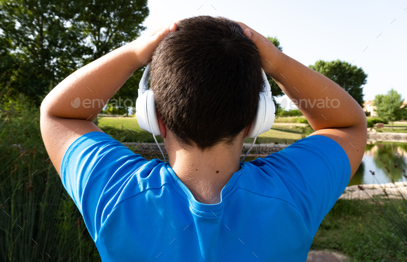 Back view of a boy with headphones and hands on the head Stock Photo by ...
