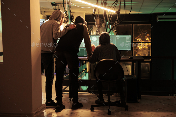 Cyber criminals team hacking database, stealing personal information Stock Photo by DC_Studio