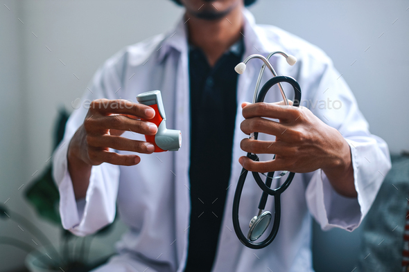 Male Doctor Showing Stethoscope and Asthma Inhaler Stock Photo by ...