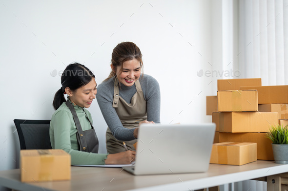 Startup small business owner working with computer at workplace. Two ...