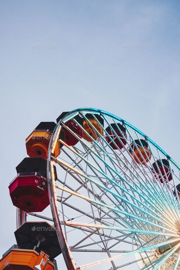 Vertical view of a colorful carrousel against the blue sky -dreamy ...