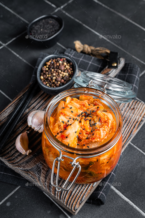 Homemade kimchi in a glass jar, traditional Korean cuisine. Black ...