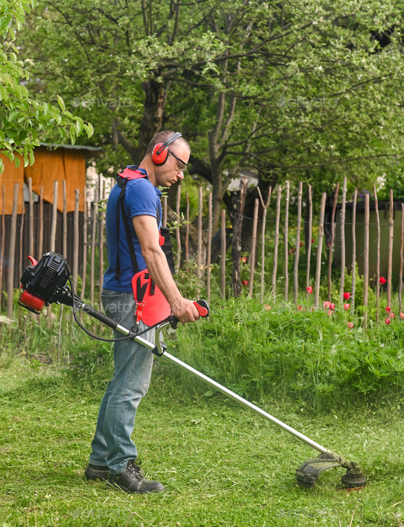 lawn trimming with hand mower. Stock Photo by ja-aljona | PhotoDune