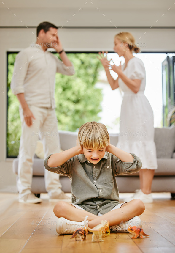 Young caucasian boy shouting, crying and covering his ears to block out ...