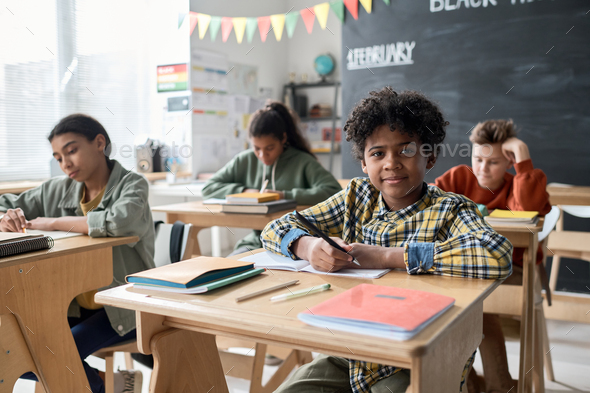 School children studying in the classroom Stock Photo by Media_photos