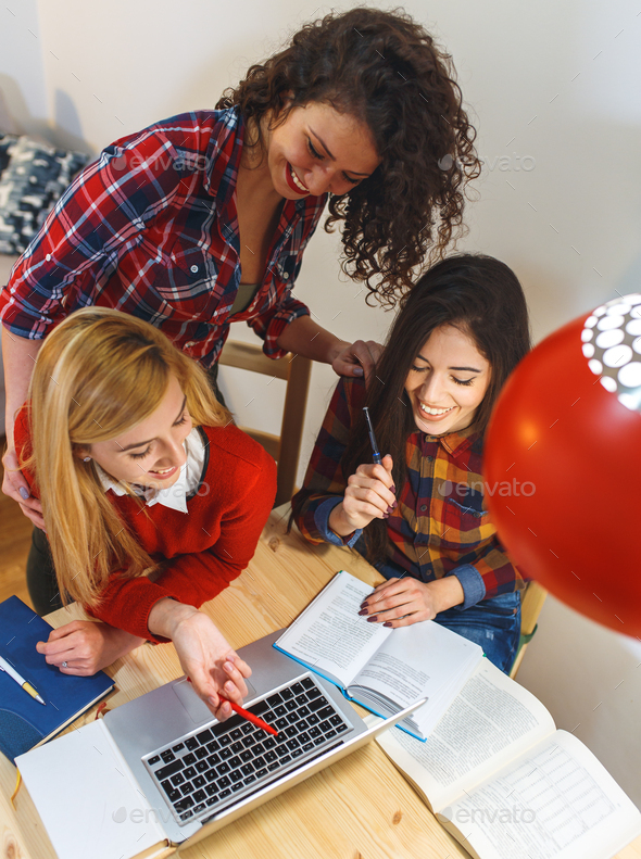 Three young female students study together at home. Stock Photo by ...