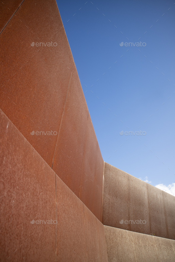 Photographic documentation of an iron wall thrown into the blue sky ...