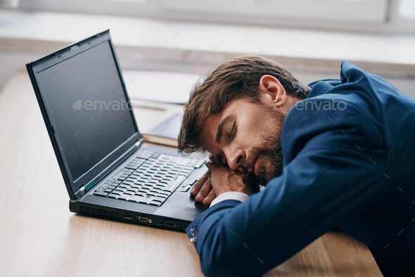 business man sleeping in front of laptop at his desk office Stock Photo ...