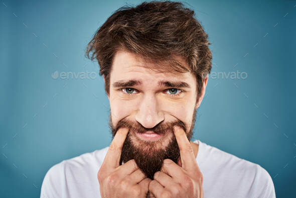 Bearded man displeased facial expression emotions close-up blue ...
