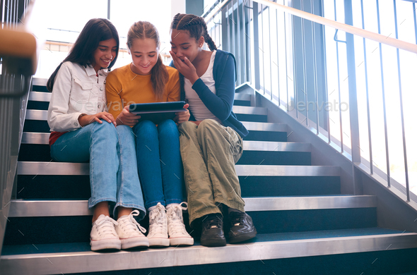 Three Female Secondary Or High School Pupils Inside School Building On ...