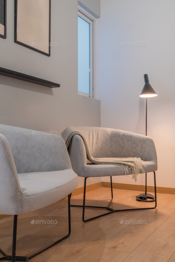 Simple remodeled living room with two comfortable chairs and lamp Stock ...