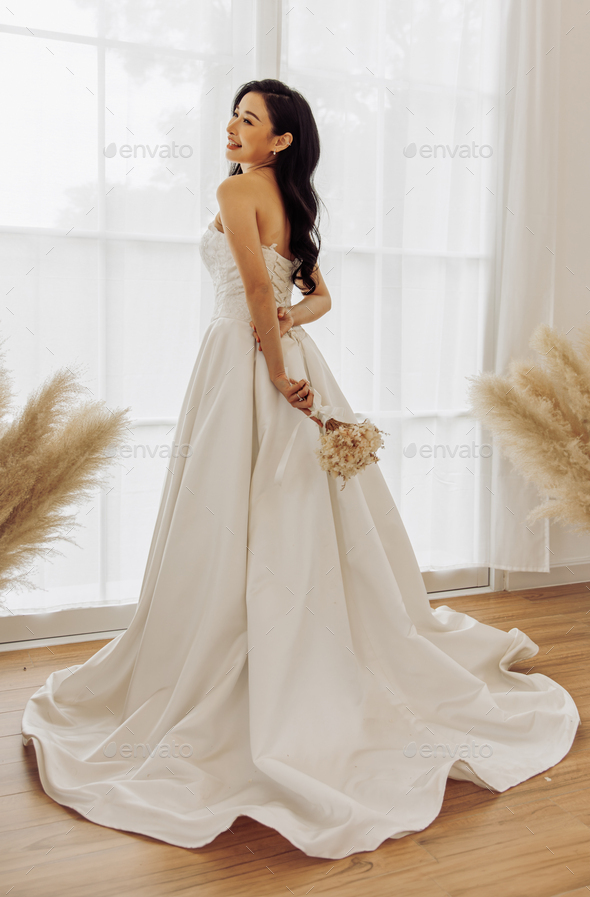 Radiant Bride in Elegant Gown by Window with Soft Backlight Stock Photo ...
