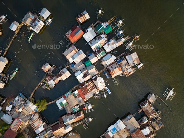 a bunch of wooden buildings are floating on a river in the middle of ...